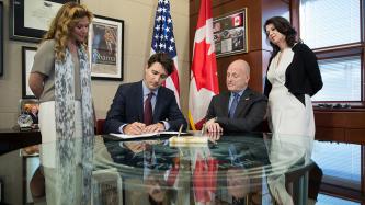 Prime Minister Justin Trudeau signs a condolence book for the victims ...
